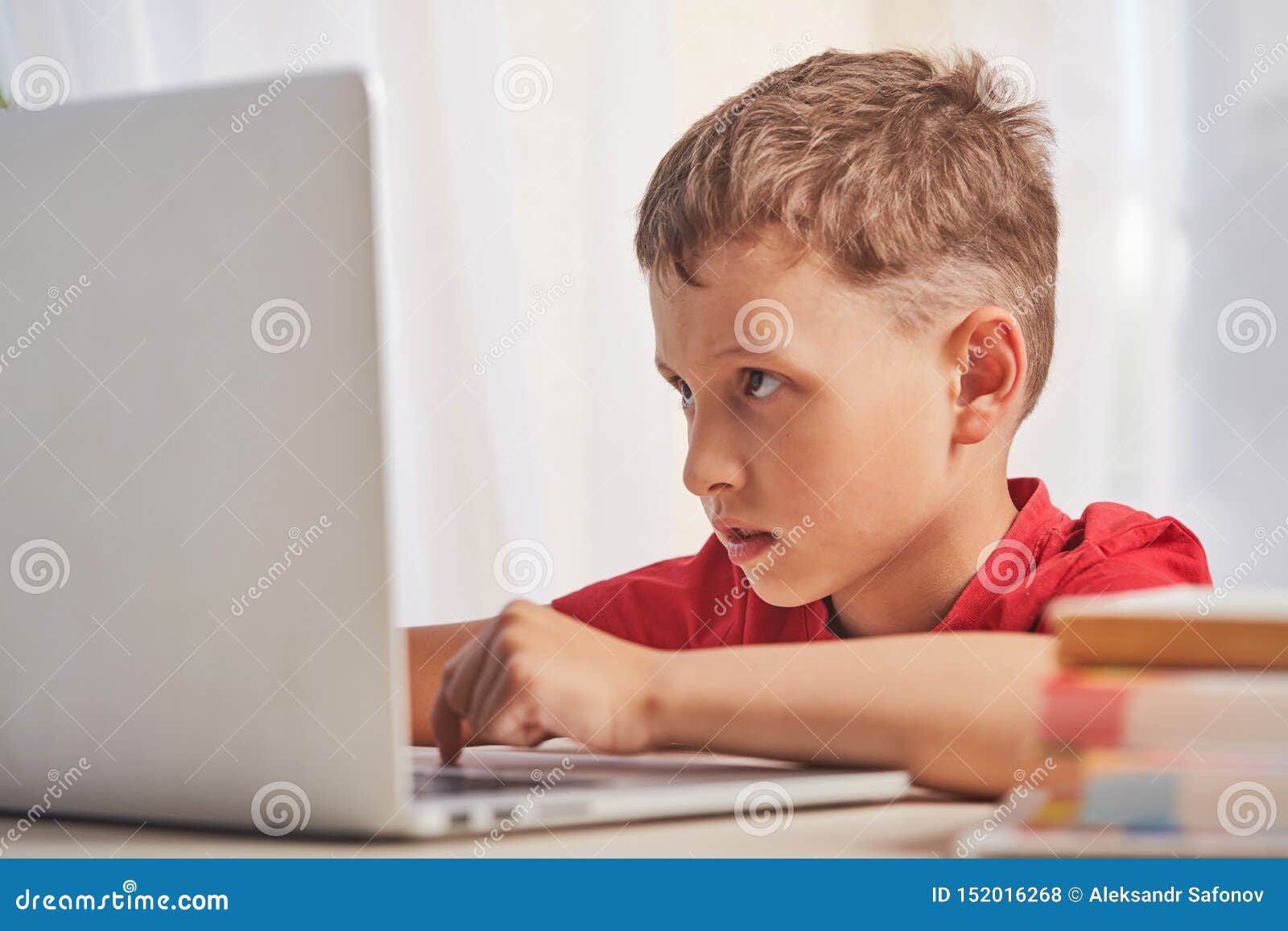 Child is Looking for Information on the Internet through a Laptop. Self ...
