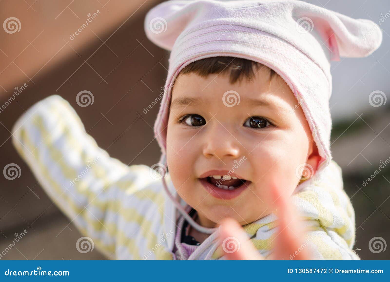 Child Looking and Pointing at Camera Smiling on a Cold Sunny Day Stock ...