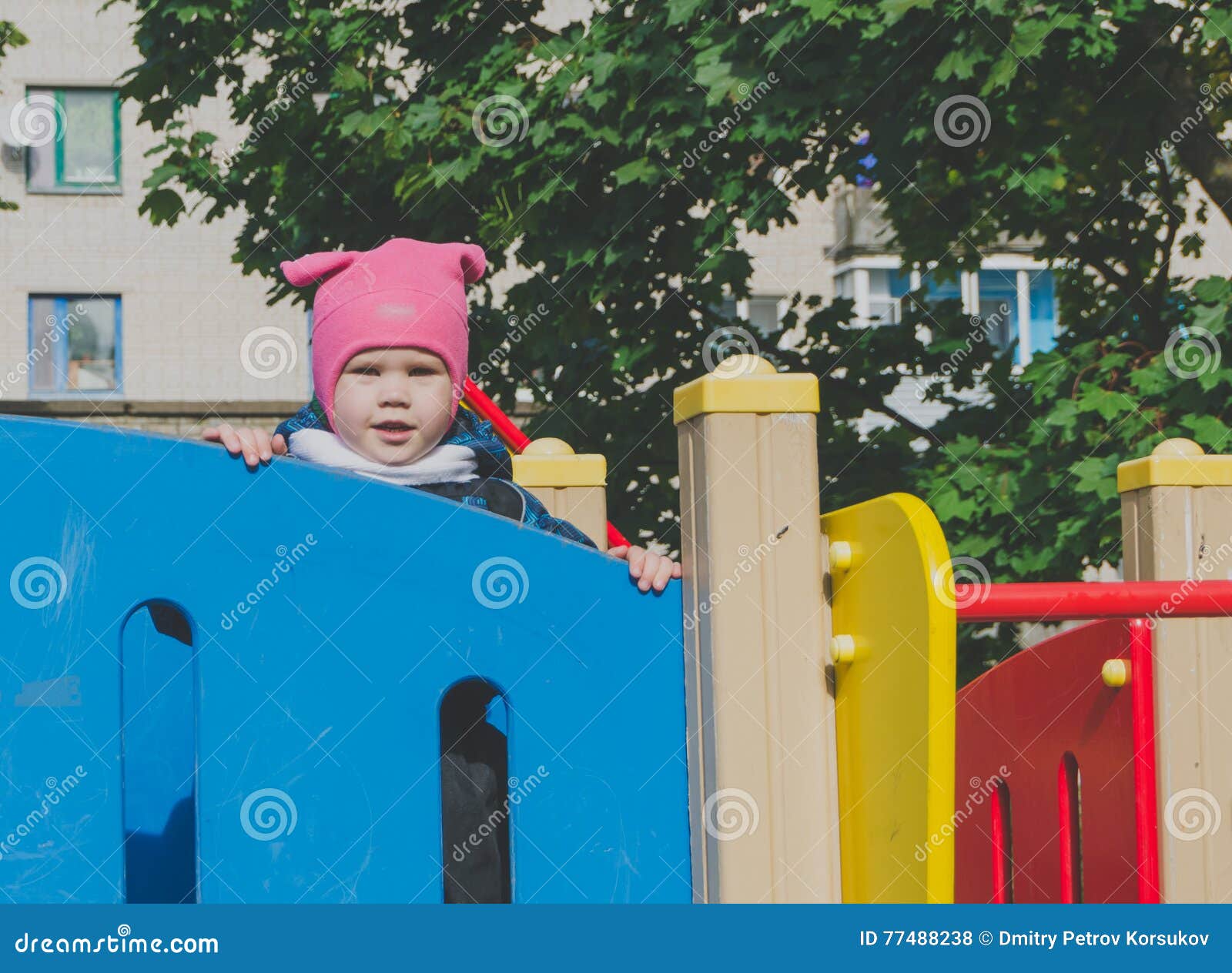 The Child Looks Over the Railing of the Playground Stock Photo - Image ...