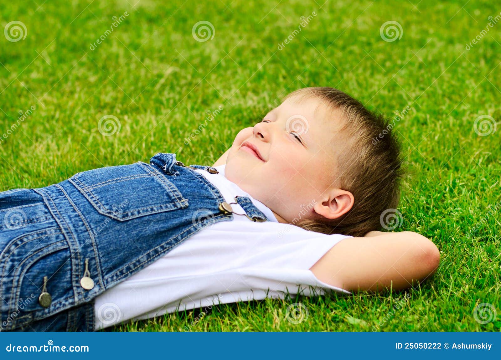 Child Lying On The Grass. Stock Photography - Image: 25050222