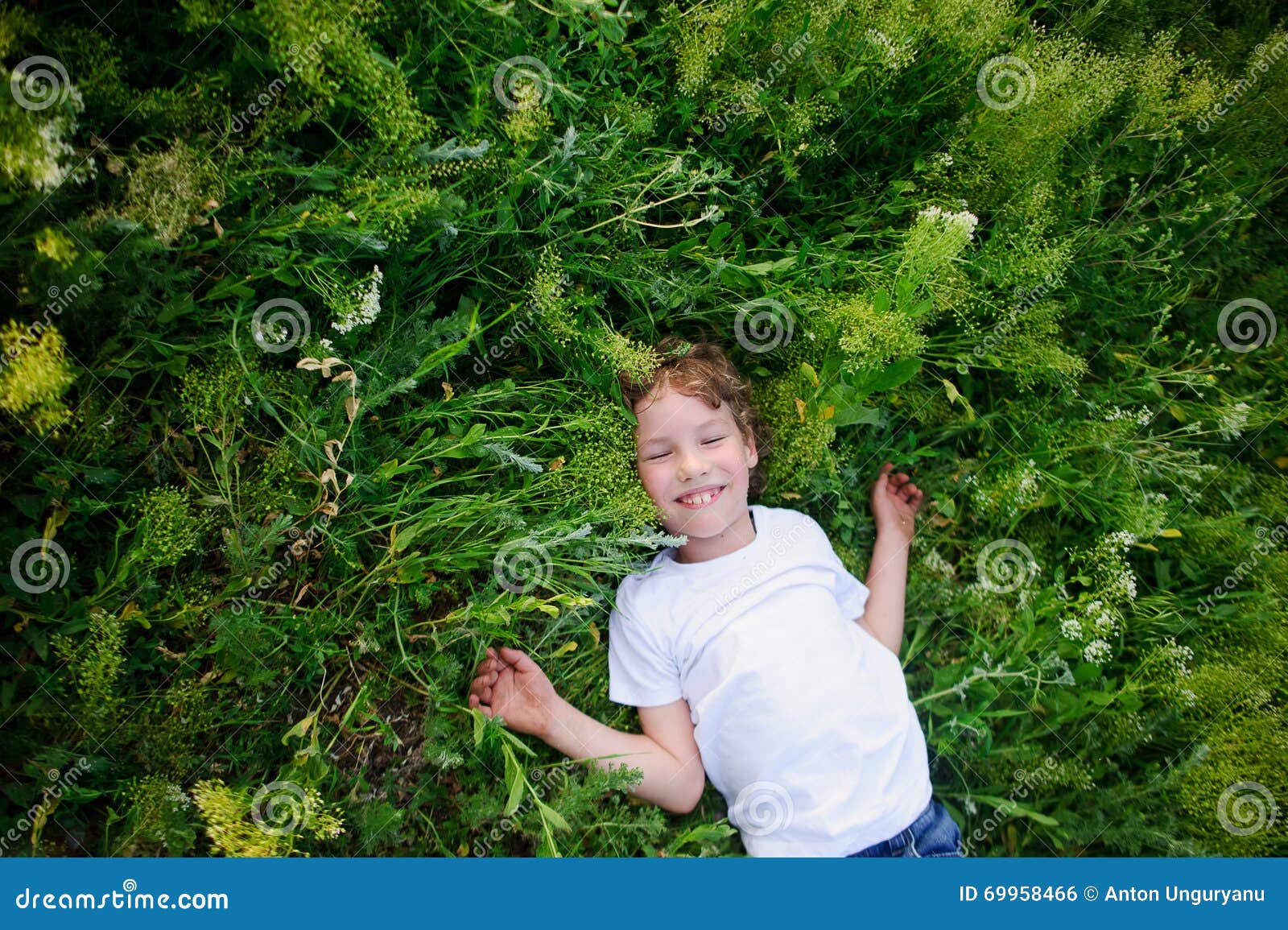 Child is Lying on the Grass Stock Photo - Image of happiness, nature ...