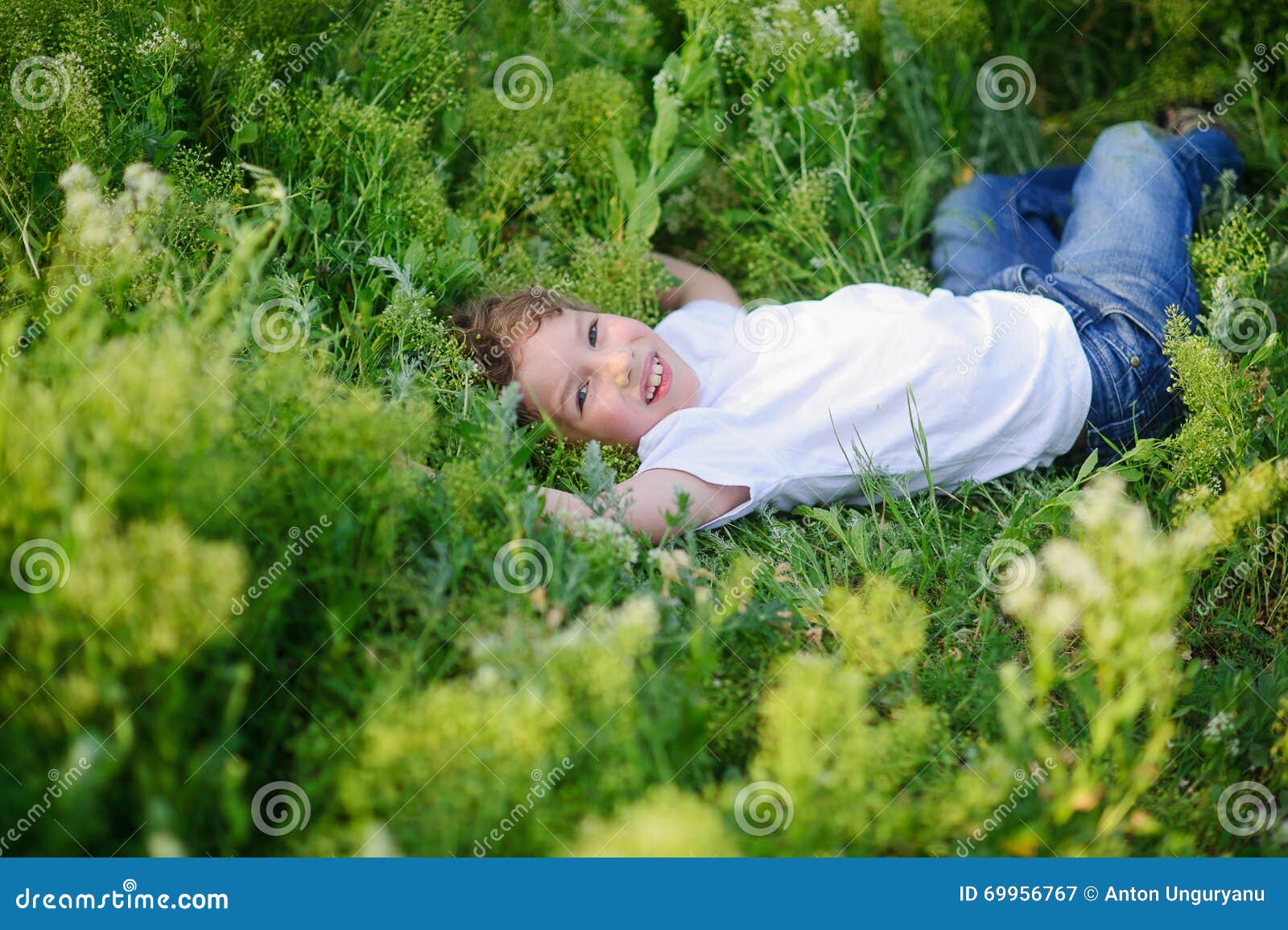 Child is Lying on the Grass Stock Image - Image of lawn, carefree: 69956767