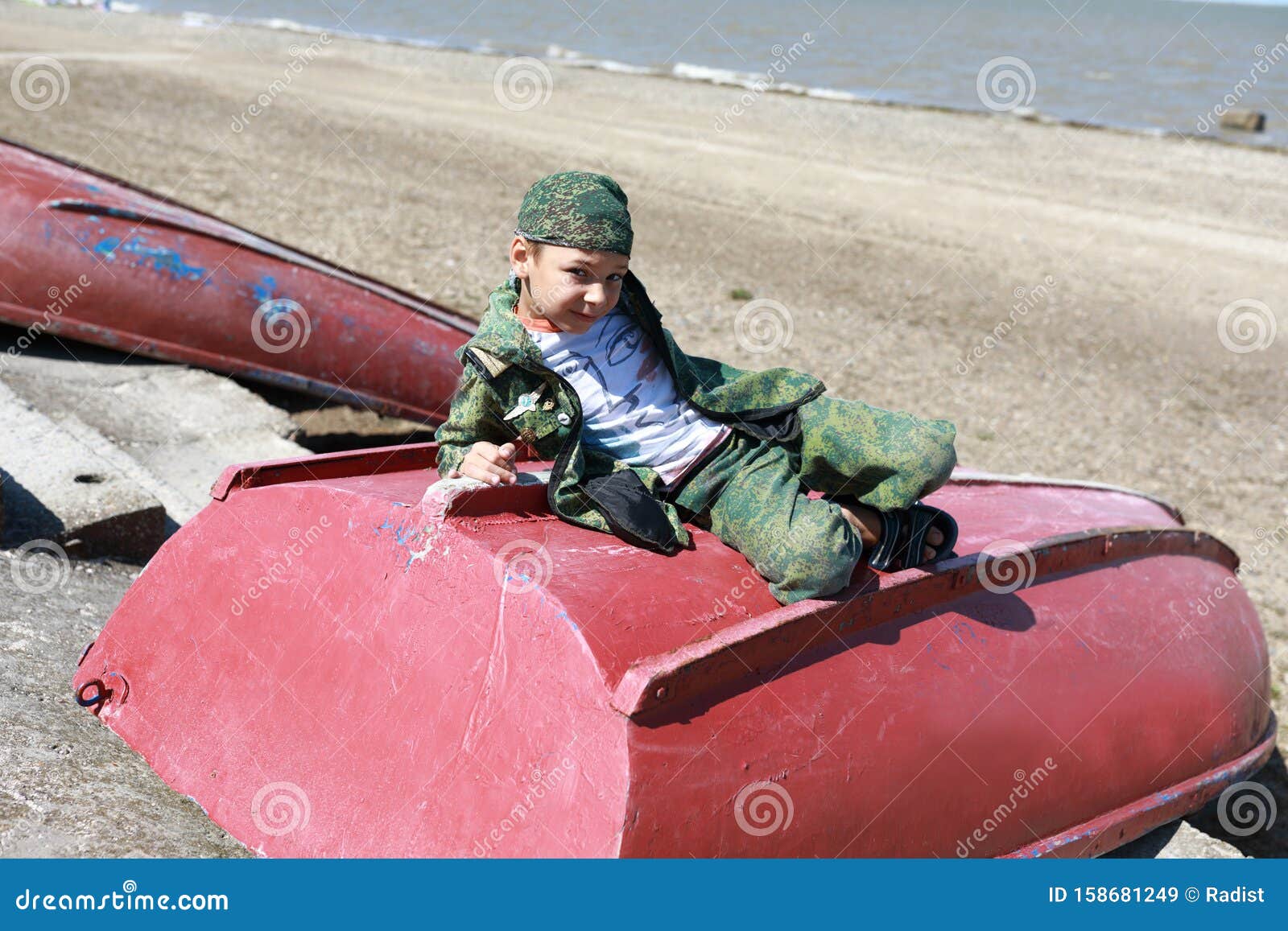Child Lying on Inverted Boat Stock Image - Image of holiday, alone ...