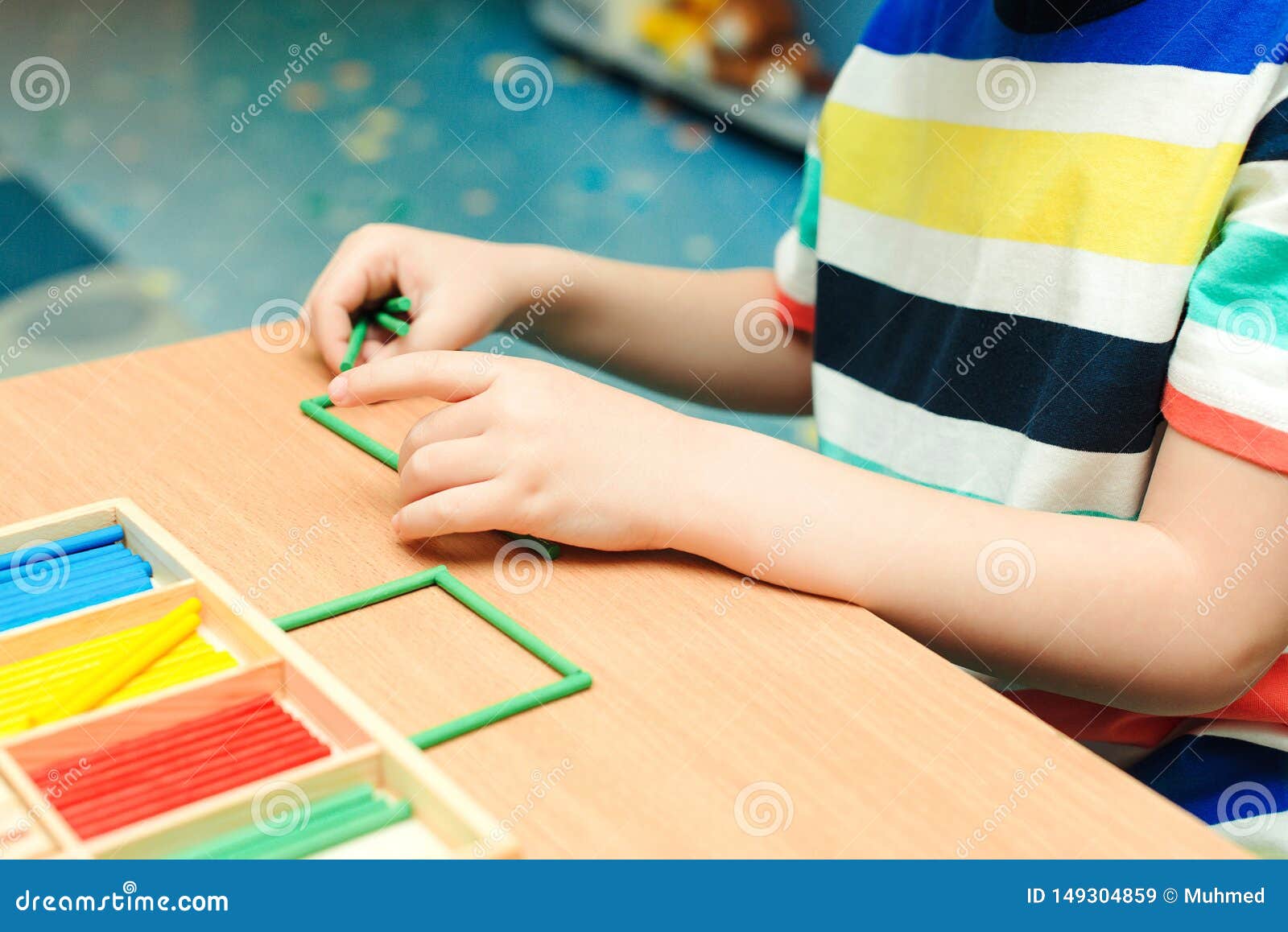 Child Makes Geometric Forms from Colorful Sticks. Preschool Education ...