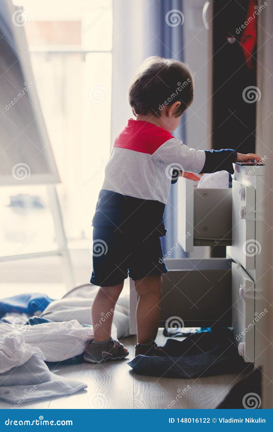 Child Makes a Mess in the Closet Stock Photo - Image of carefree ...