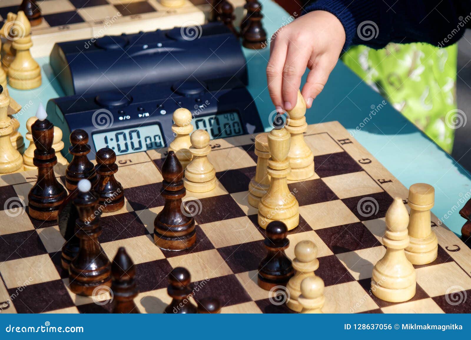 The Child Makes a Move in a Chess Game. Stock Photo - Image of ...