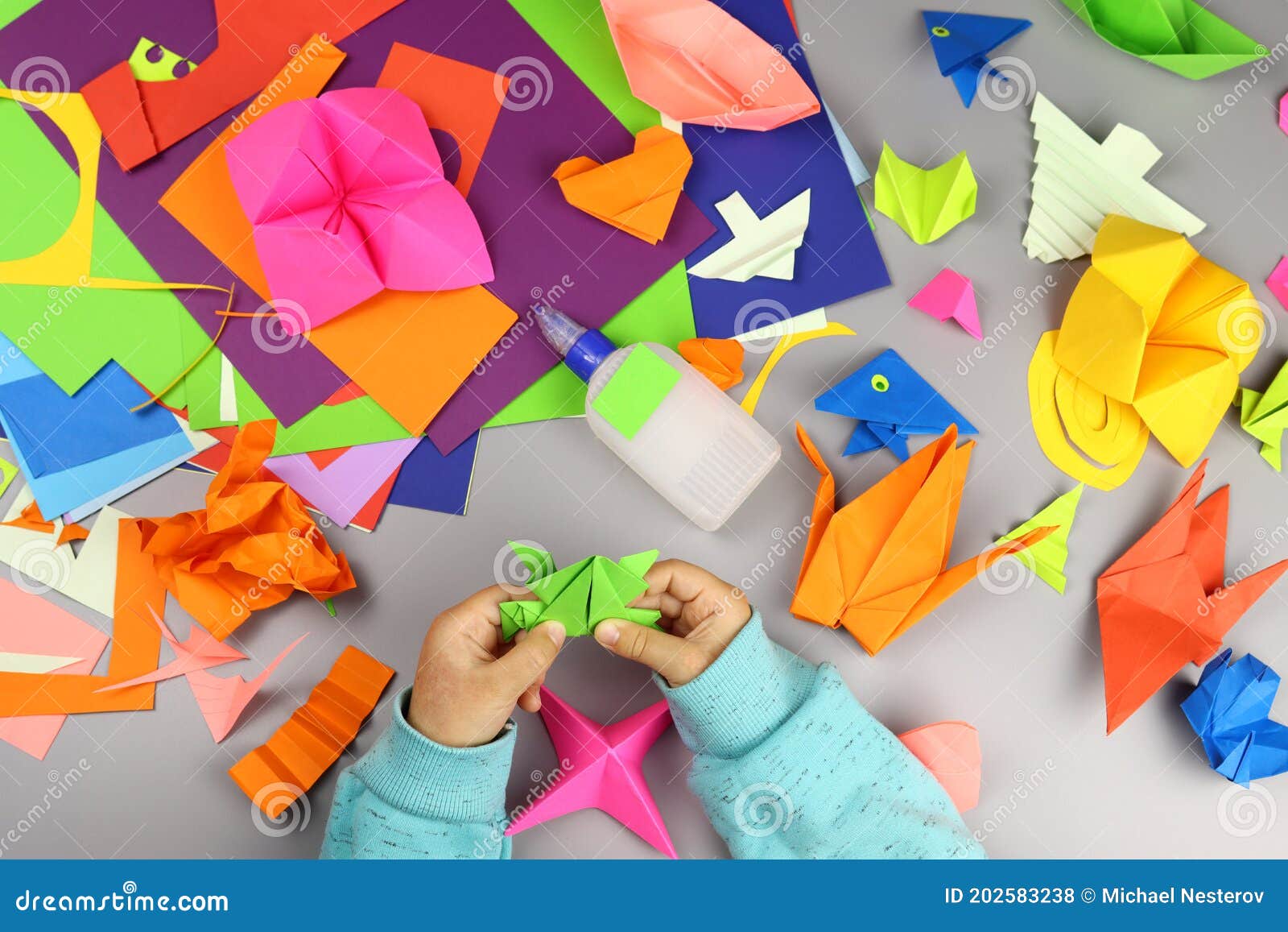 Child Makes Origami Crafts from Colored Paper Stock Photo - Image of ...