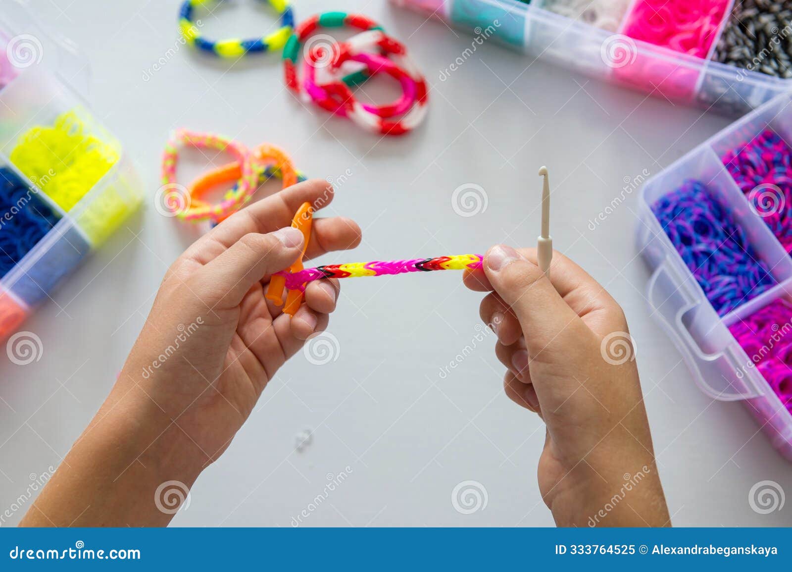 Child Making Colorful Rubber Band Bracelet with a Loom Tool Stock ...