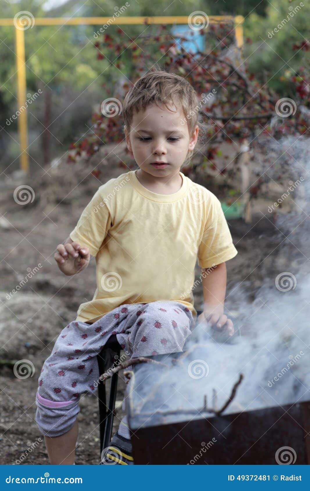 Child making fire in grill stock image. Image of firewood - 49372481