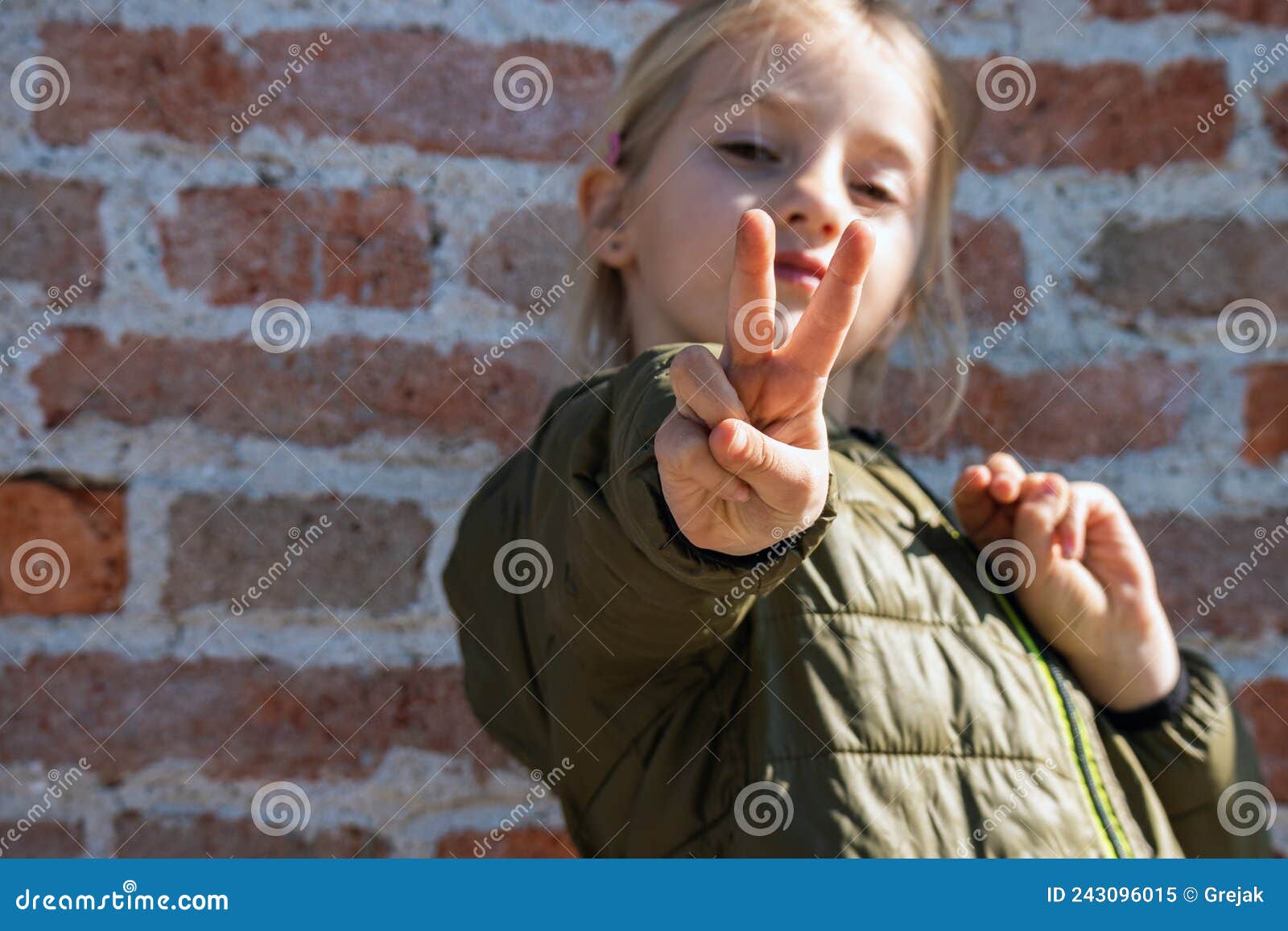Child Making Peace Sign stock image. Image of child - 243096015