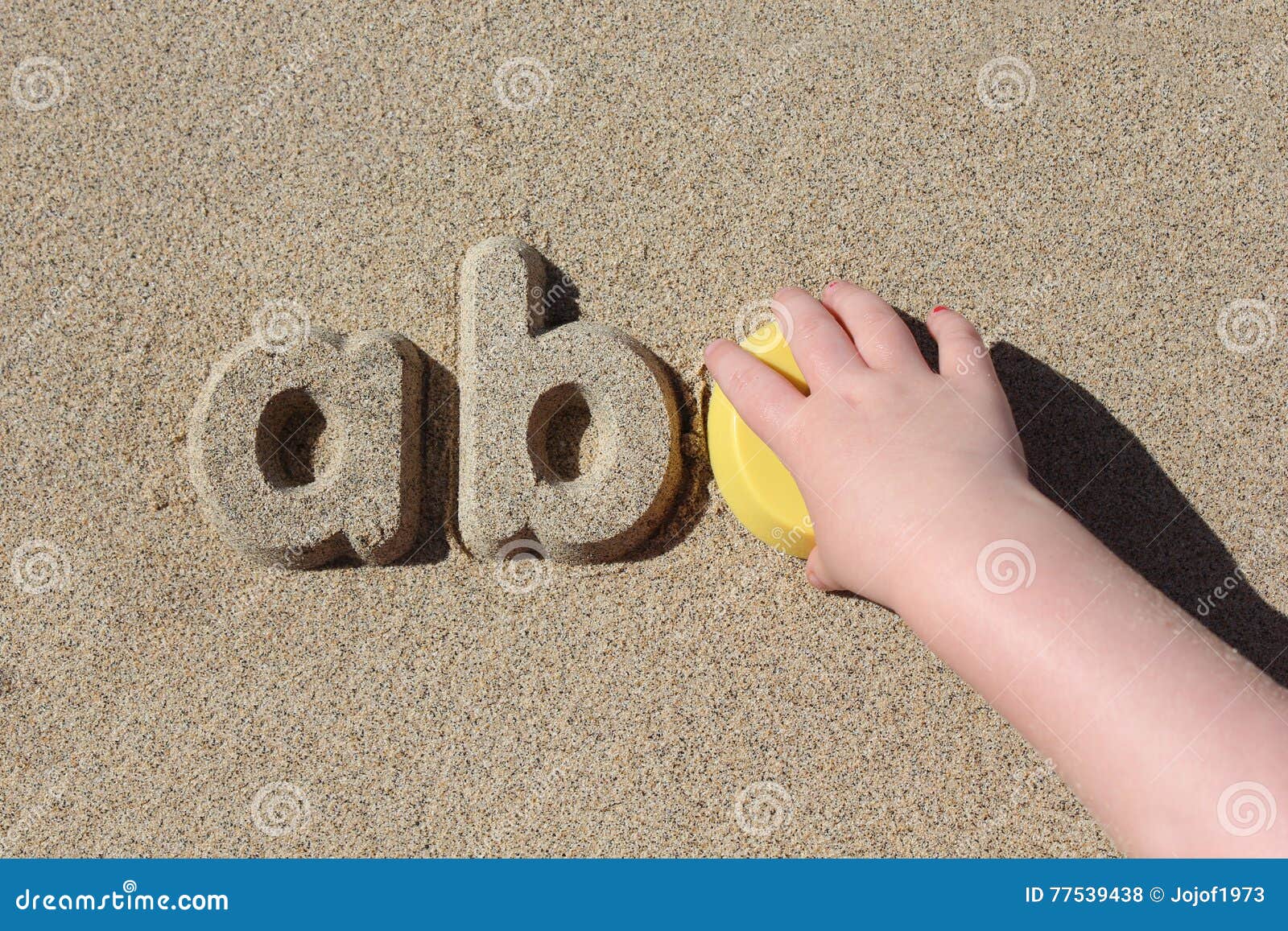 A Child Making Sand Letters on the Beach Stock Photo - Image of bright ...