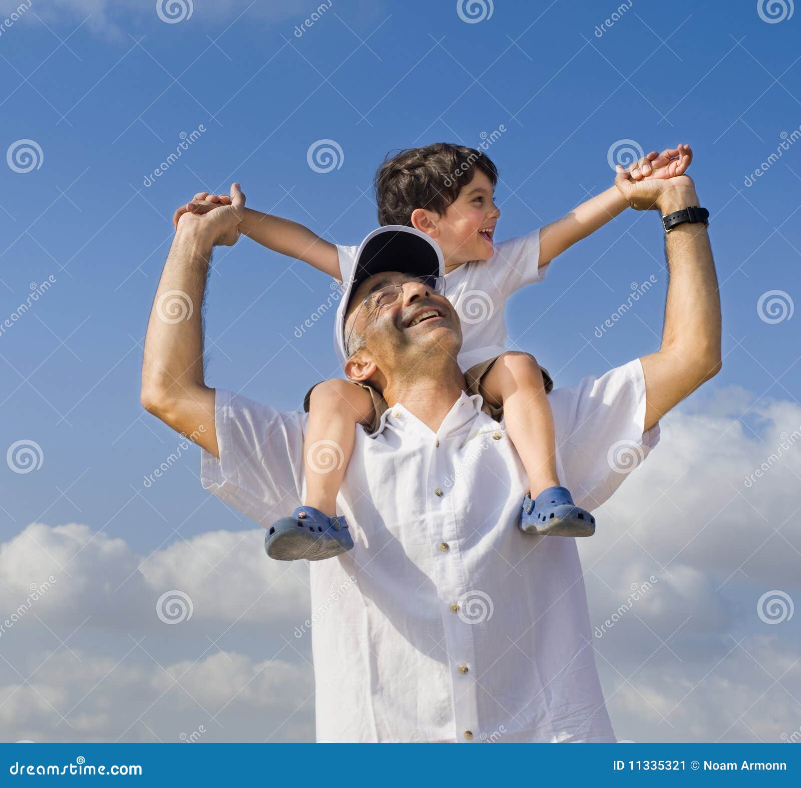 Child on man shoulders stock image. Image of blue, outside - 11335321