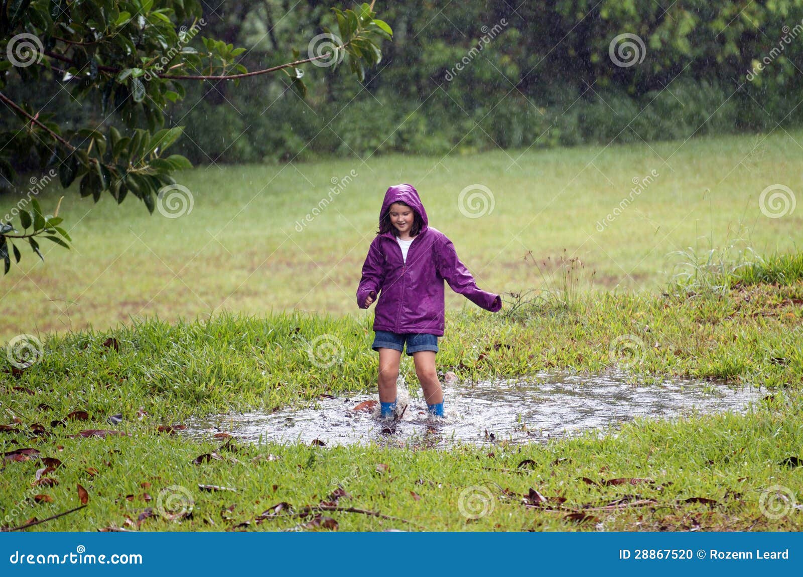 Child in muddy puddle stock photo. Image of playtime - 28867520