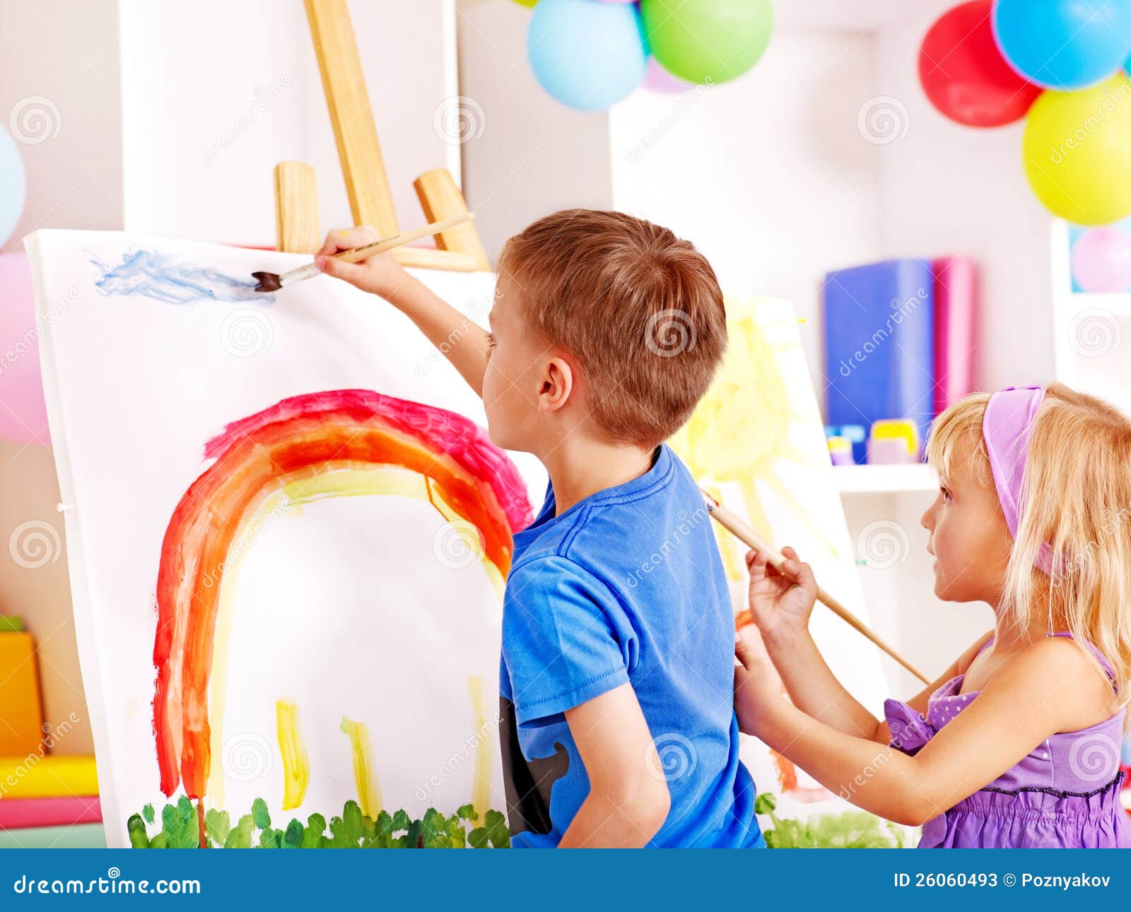 Child painting at easel. stock image. Image of classroom - 26060493