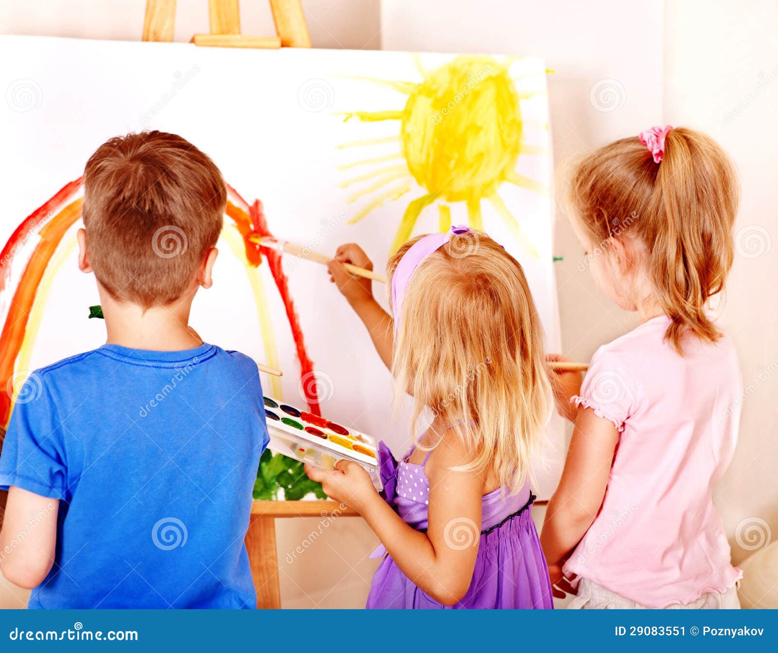 Child painting at easel. stock image. Image of indoors - 29083551