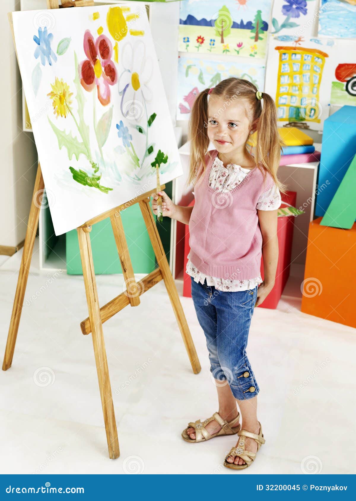 Child painting at easel. stock image. Image of nursery - 32200045