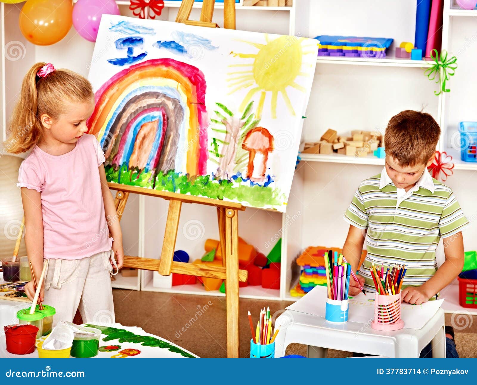 Child painting at easel. stock photo. Image of kindergarten - 37783714