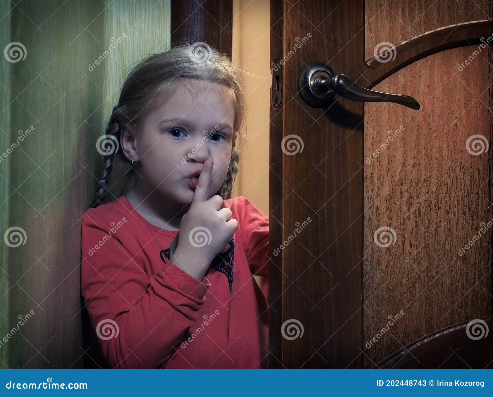Child Peeps out and shows stock image. Image of blond - 202448743