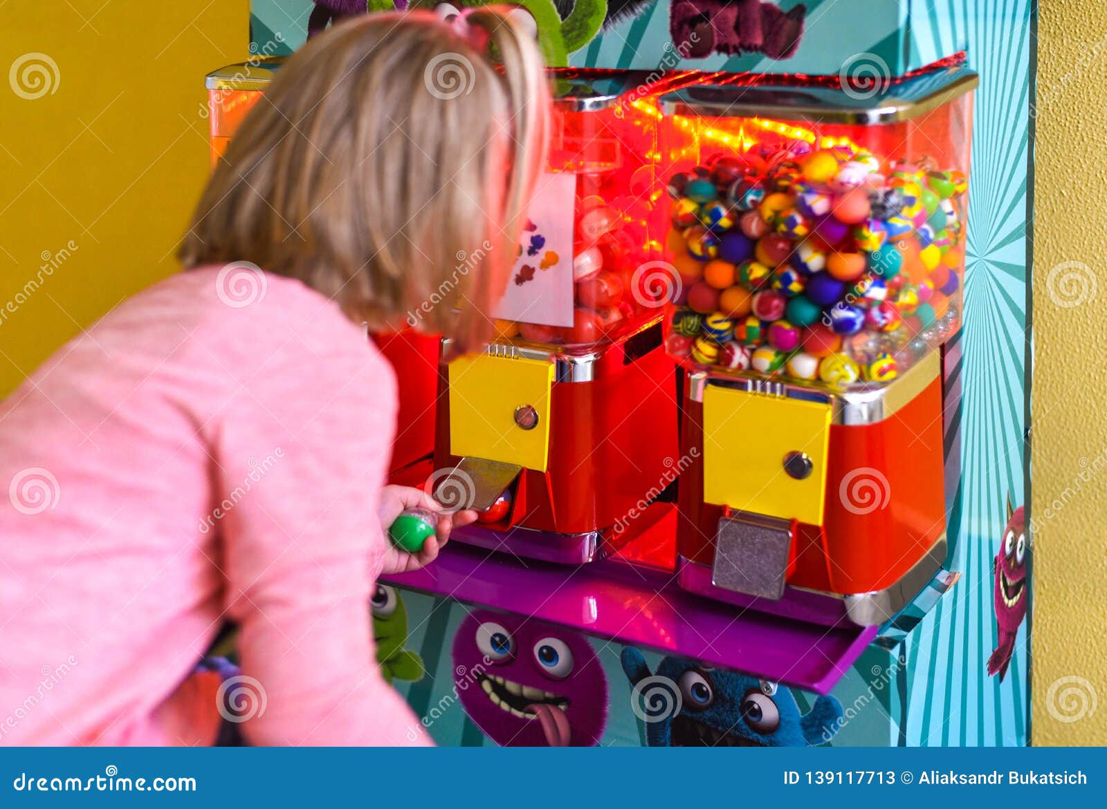 The Child Picks Up a Gift in the Machine with Toys Stock Image - Image ...
