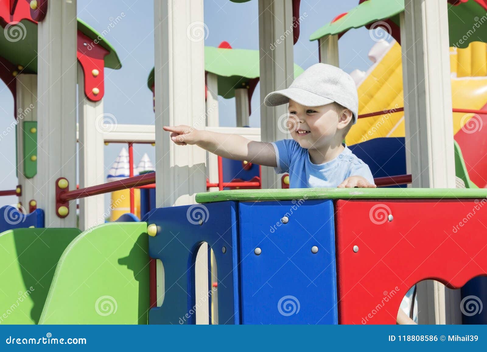 The Child on the Playground Points into the Distance. Stock Photo ...