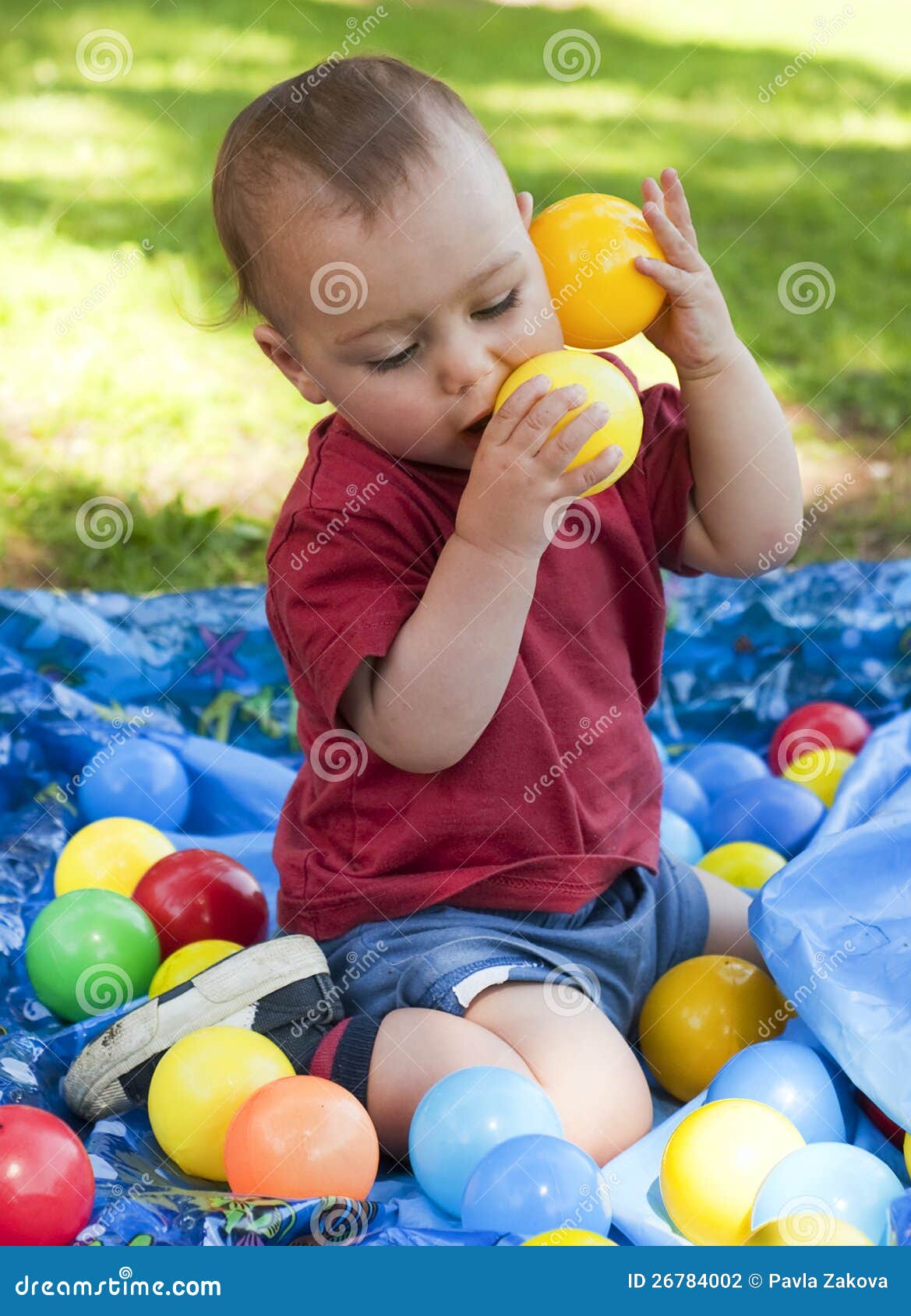 Child Playing with Balls in Garden Stock Photo - Image of expressions ...
