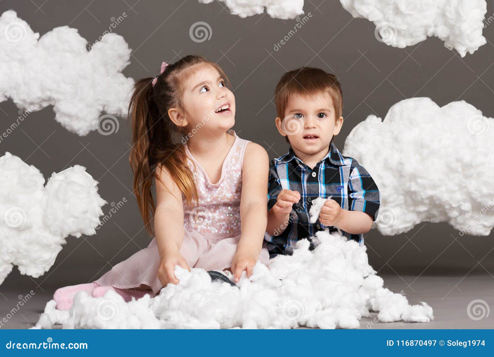 Child Playing with Clouds, Shot in the Studio on a Gray Background ...