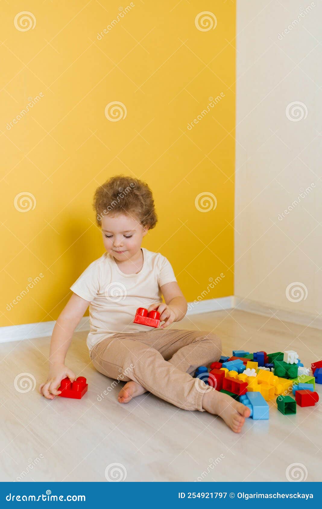 Child is Playing with Colorful Cubes at the Table. Kid Has Fun and ...