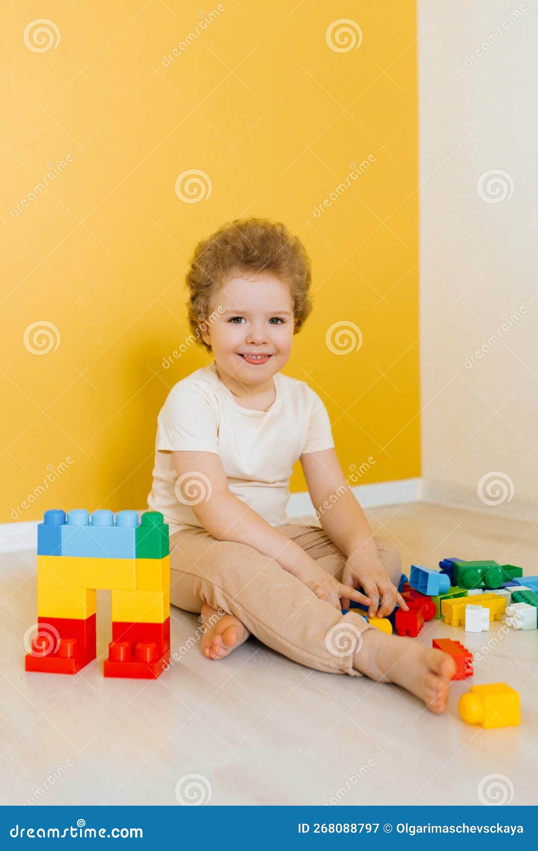 Child is Playing with Colorful Cubes at the Table. Kid Has Fun and ...