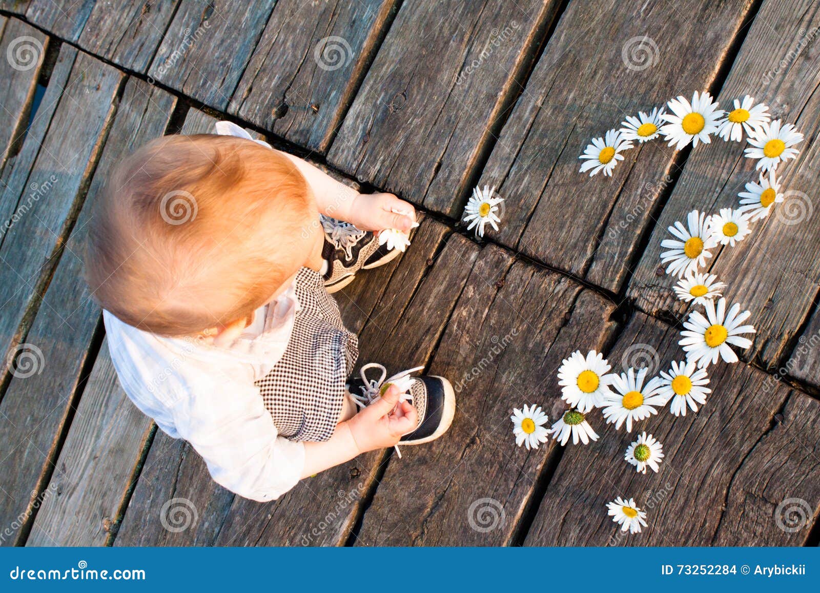 Child playing with flowers stock photo. Image of people - 73252284