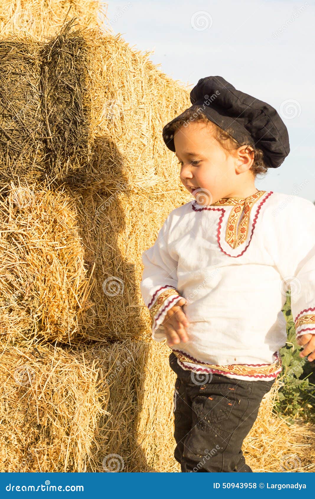 Child Playing in a Haystack. Stock Photo - Image of costume, childhood ...