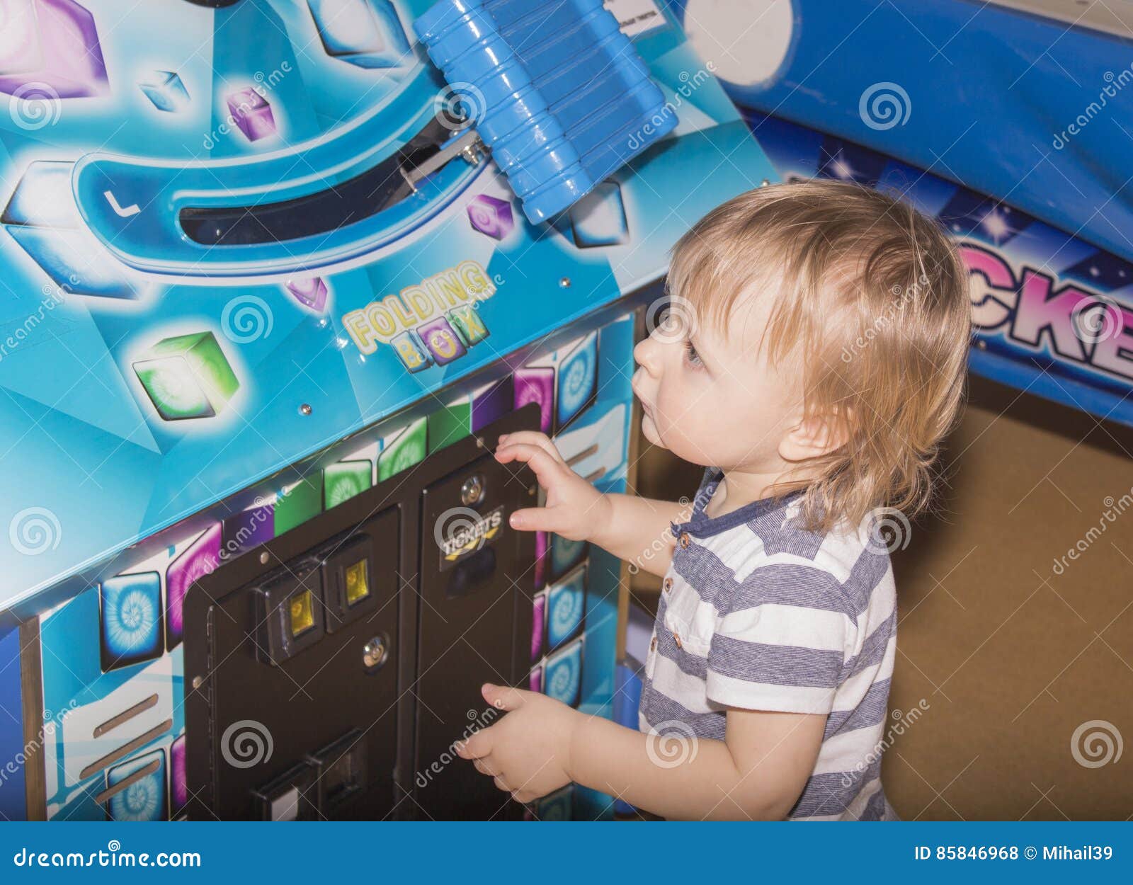 Child Playing on the Kids Game Machine at an Amusement Park Stock Photo ...