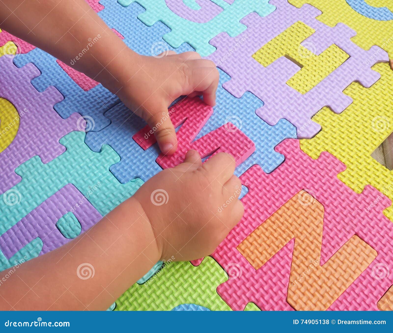Child Playing and Learning Letters with Colorful Puzzles Stock Photo ...