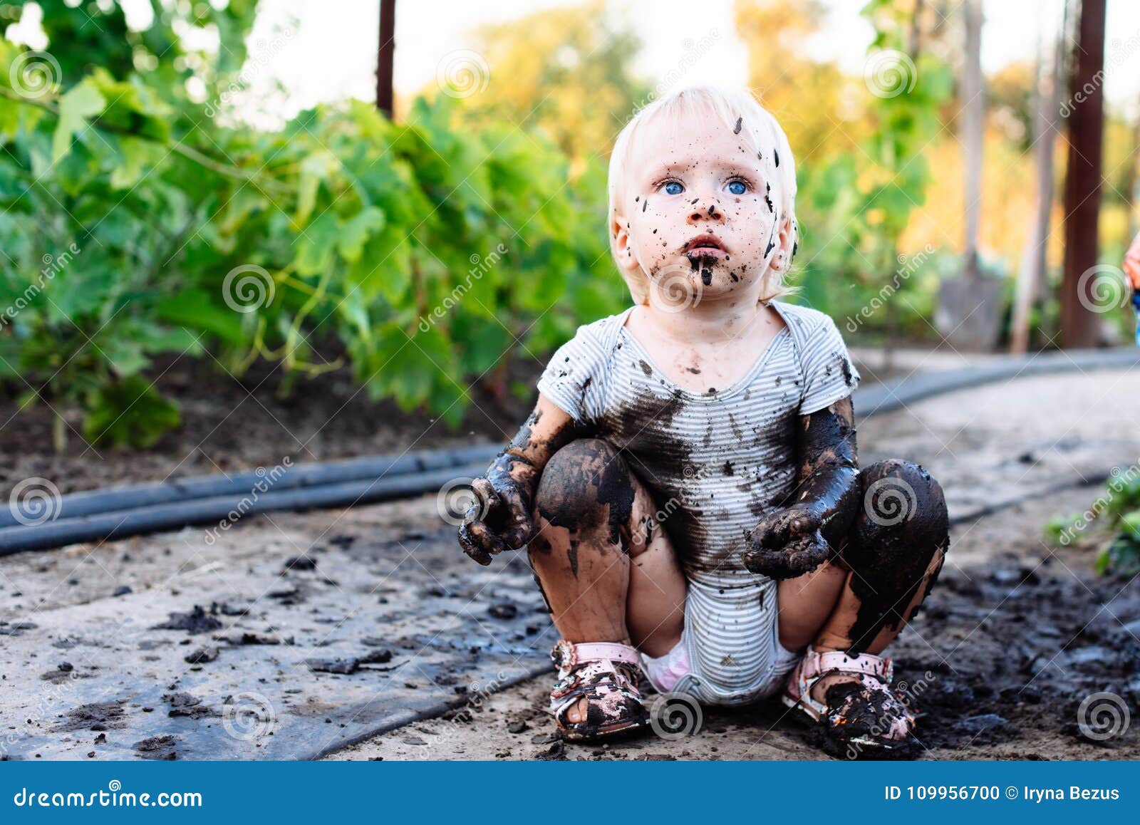 Child Playing in the Mud on the Street Stock Photo - Image of baby ...