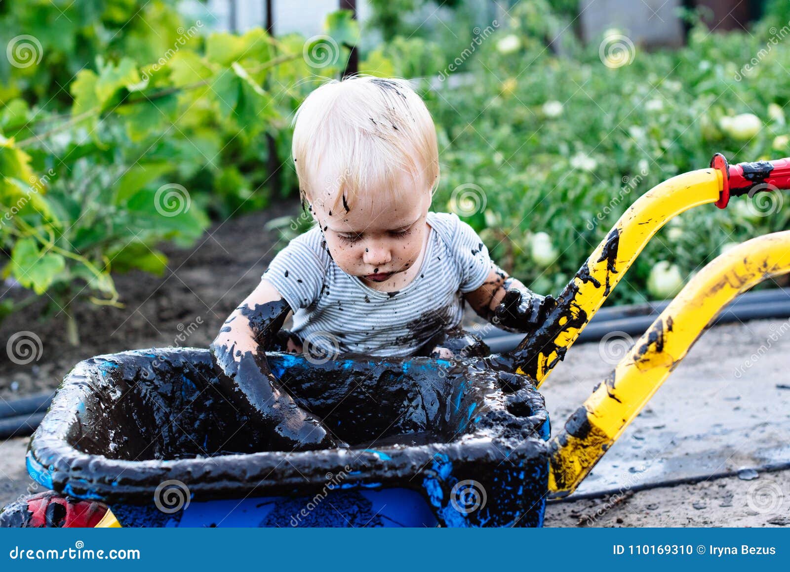 Child Playing in the Mud on the Street Stock Photo - Image of young ...