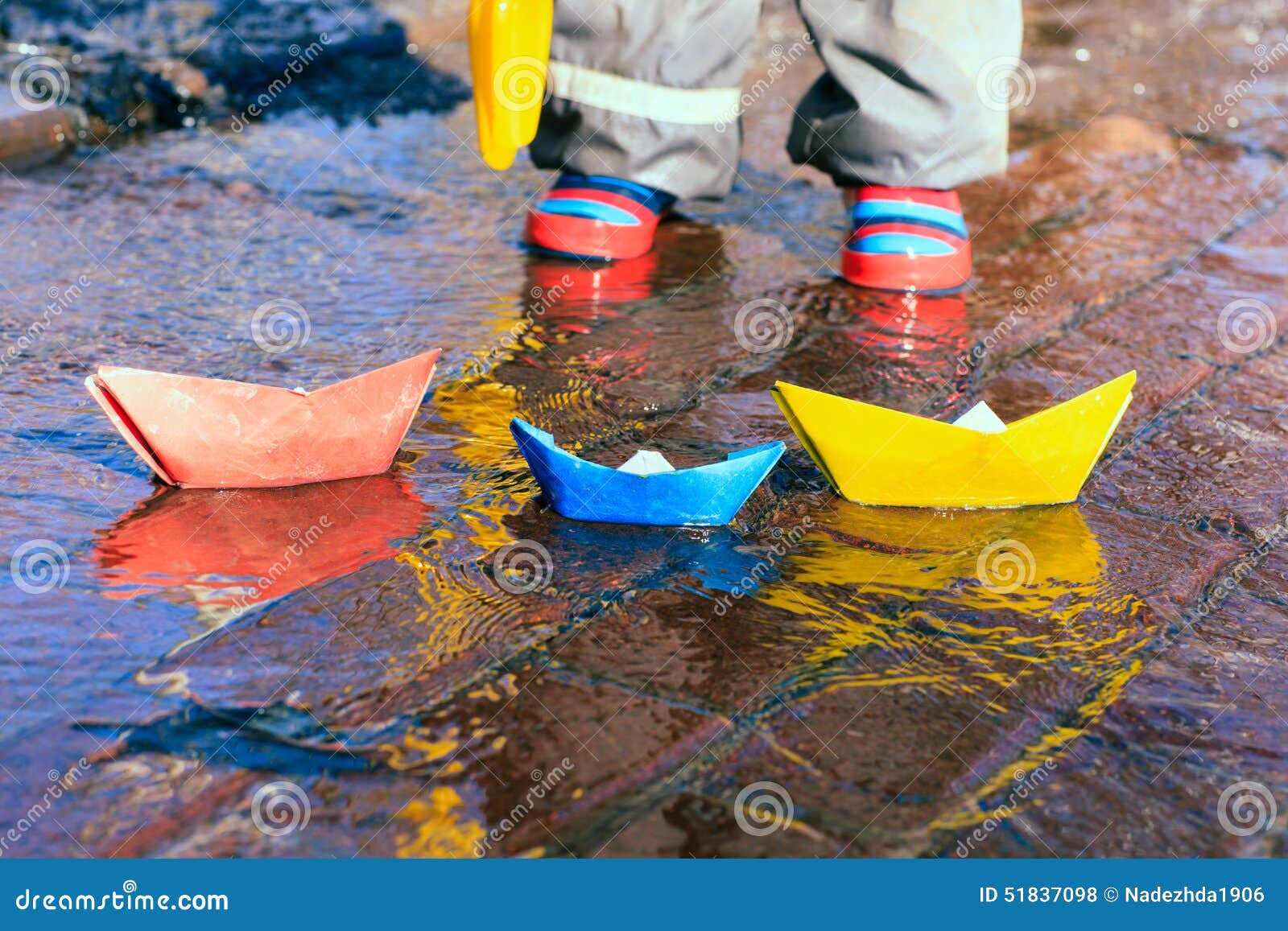 Child Playing with Paper Boats in Water Puddle Stock Photo - Image of ...