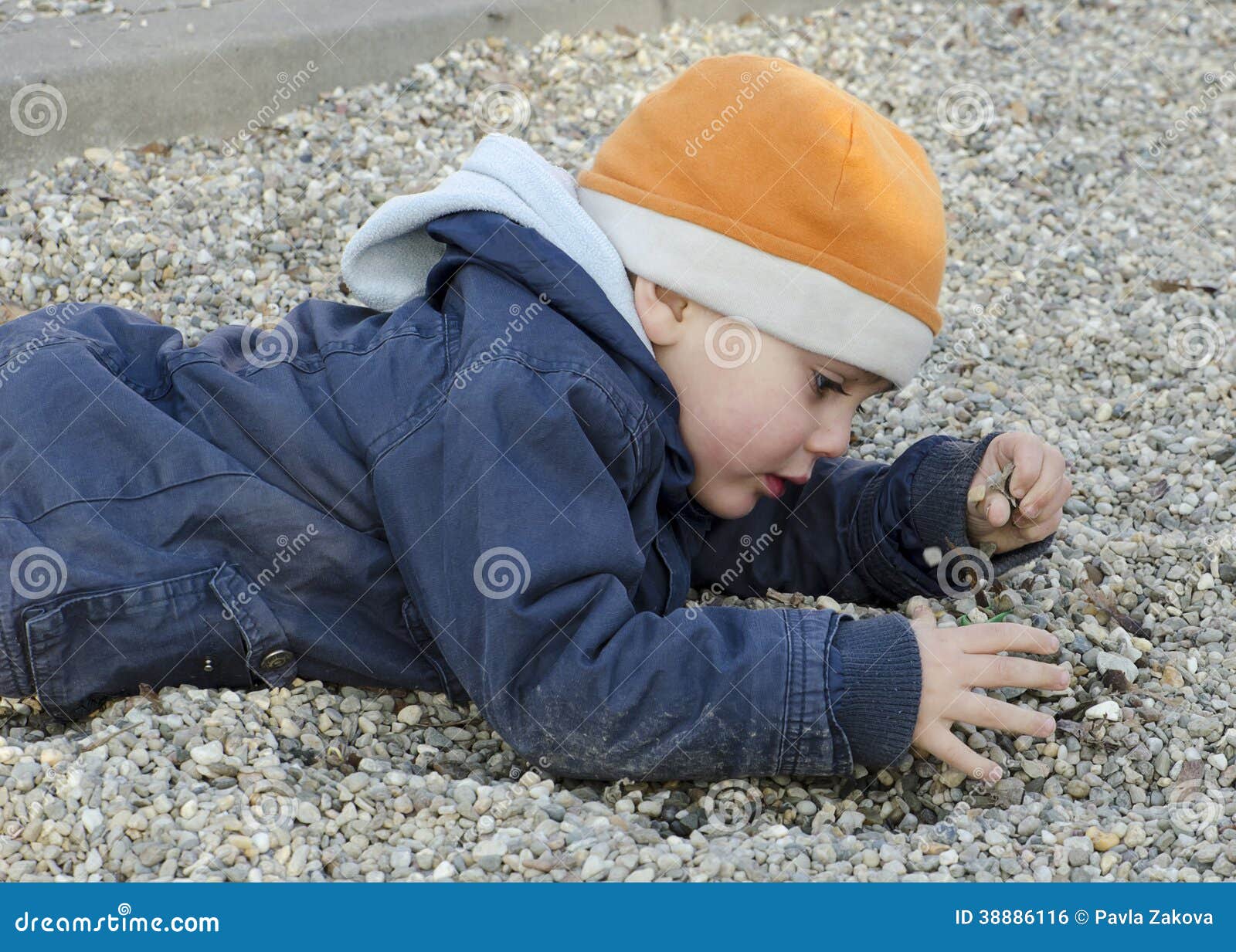 Child playing with pebbles stock photo. Image of stone - 38886116