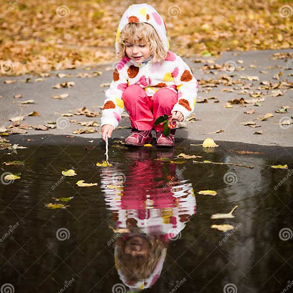 Child playing in puddle stock photo. Image of outdoors - 25160556