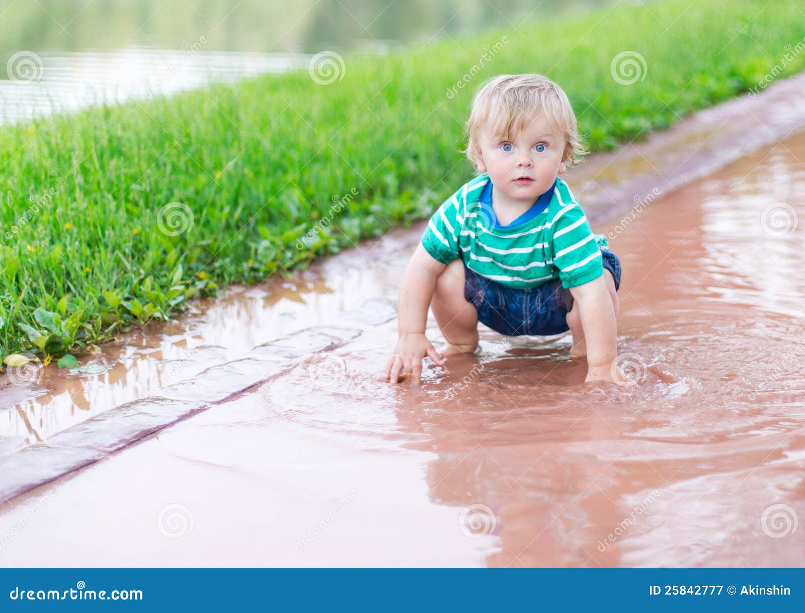 Child playing in a puddle stock image. Image of ecology - 25842777