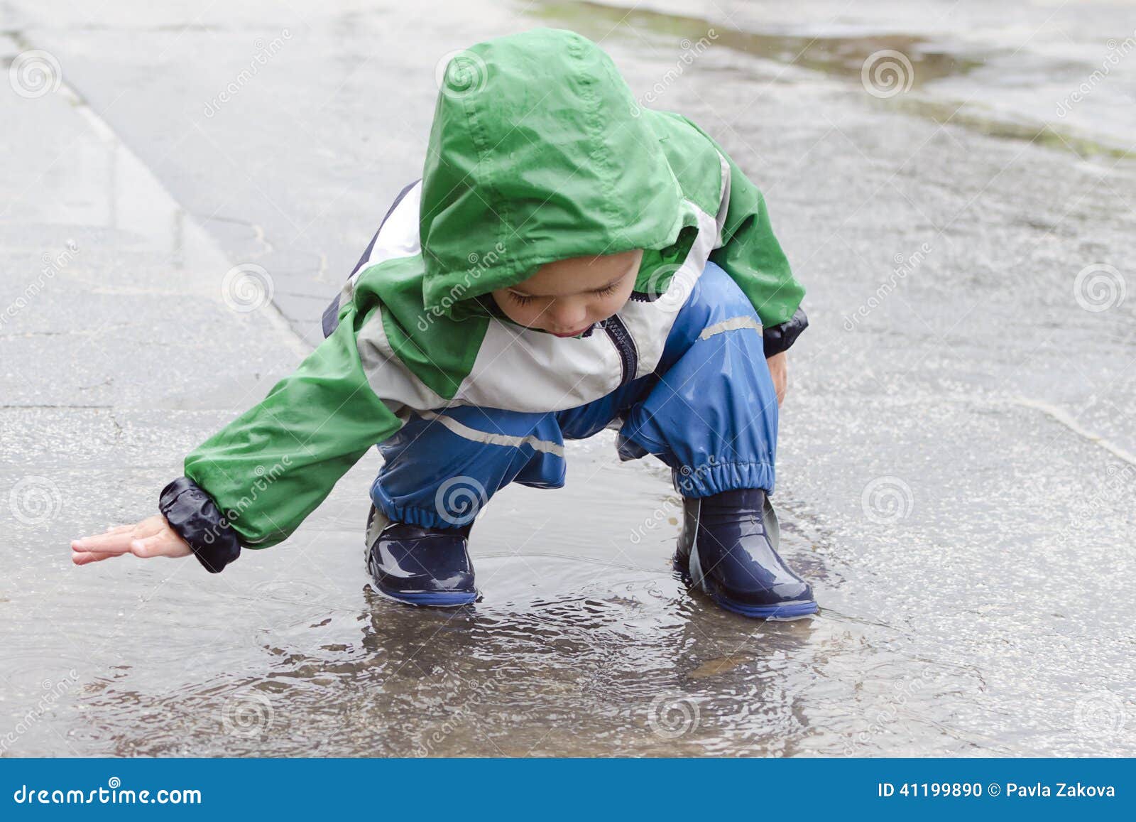 Child playing in puddle stock photo. Image of boots, dirt - 41199890