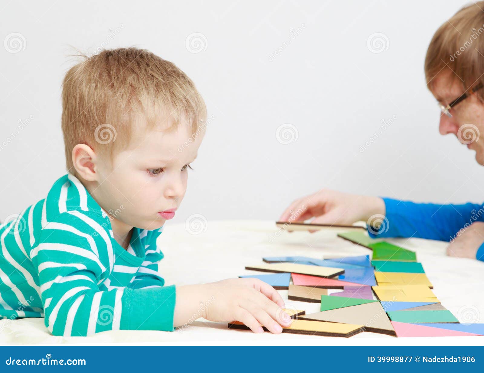 Child playing with puzzle stock image. Image of game - 39998877