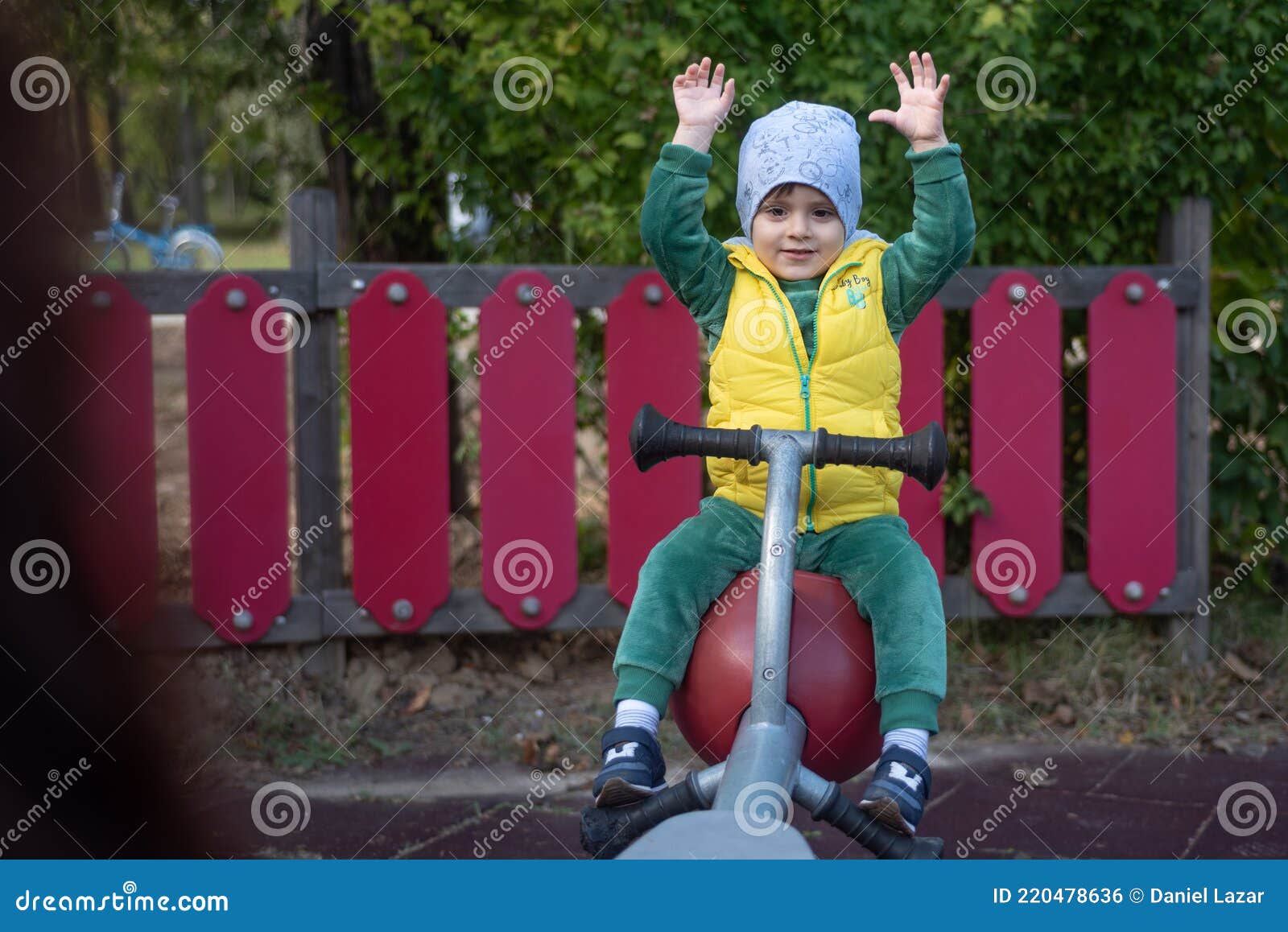 Child playing in a rocker stock photo. Image of smiling - 220478636