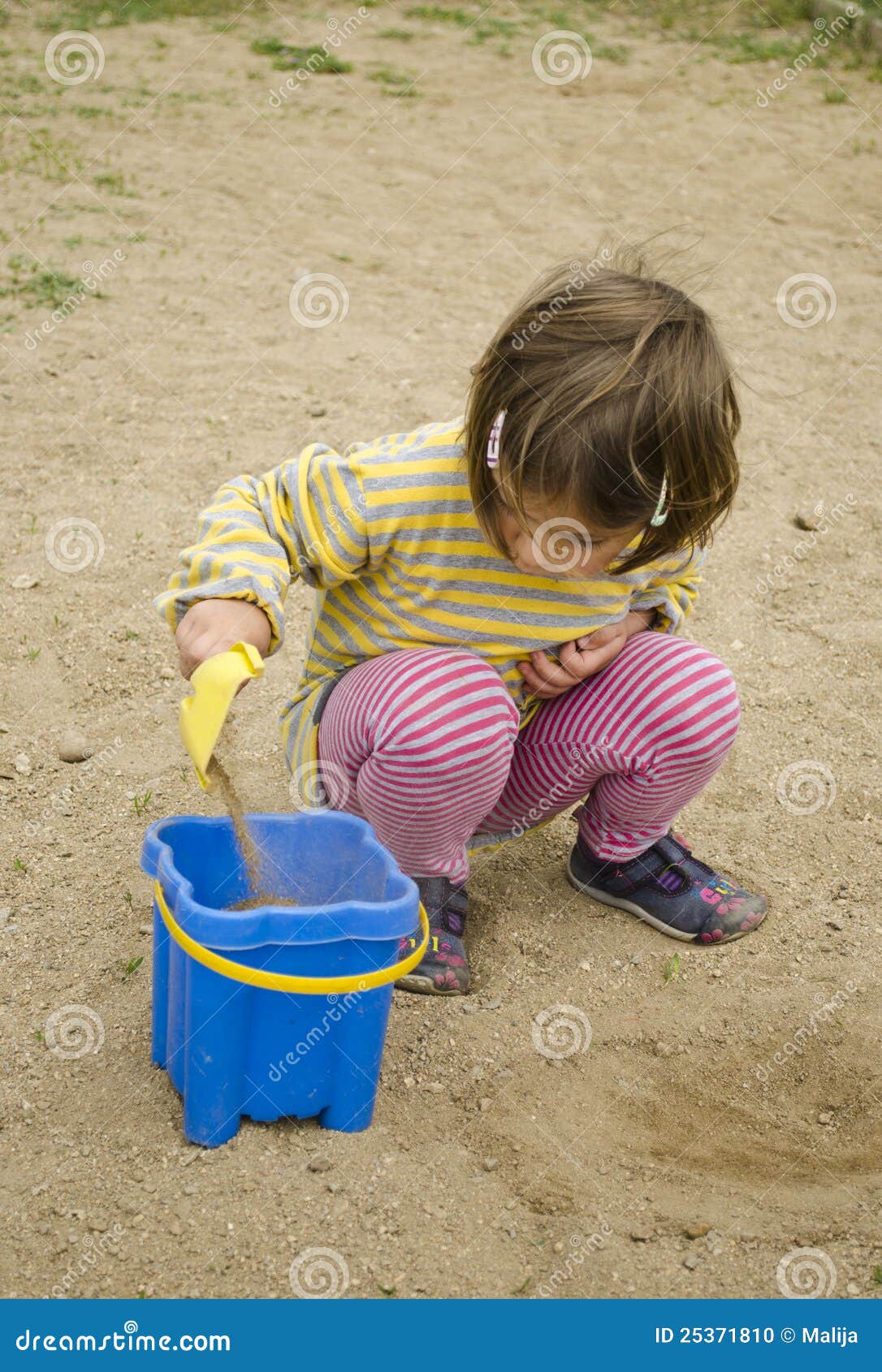 Child playing in the sand stock photo. Image of activity - 25371810
