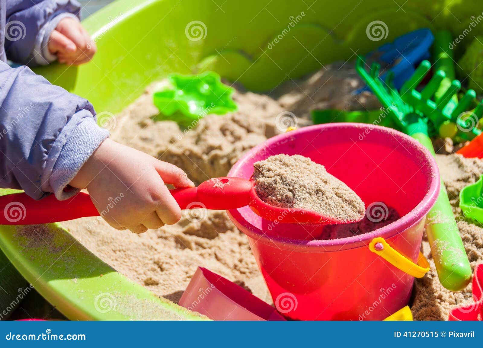 Child playing in sandbox stock image. Image of playing - 41270515