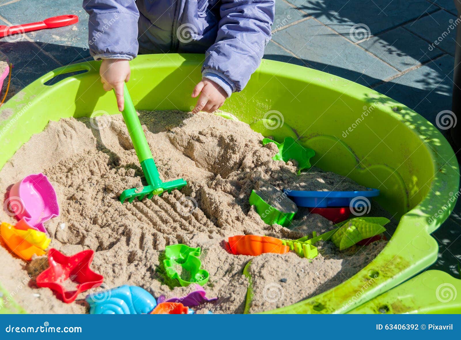 Child playing in sandbox stock photo. Image of sandbox - 63406392