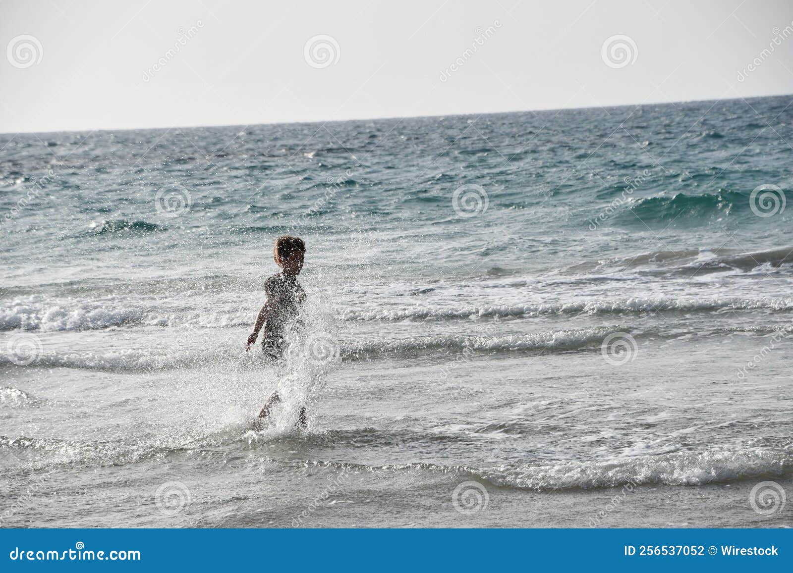 Child Playing by the Seashore Stock Photo - Image of ocean, coast ...