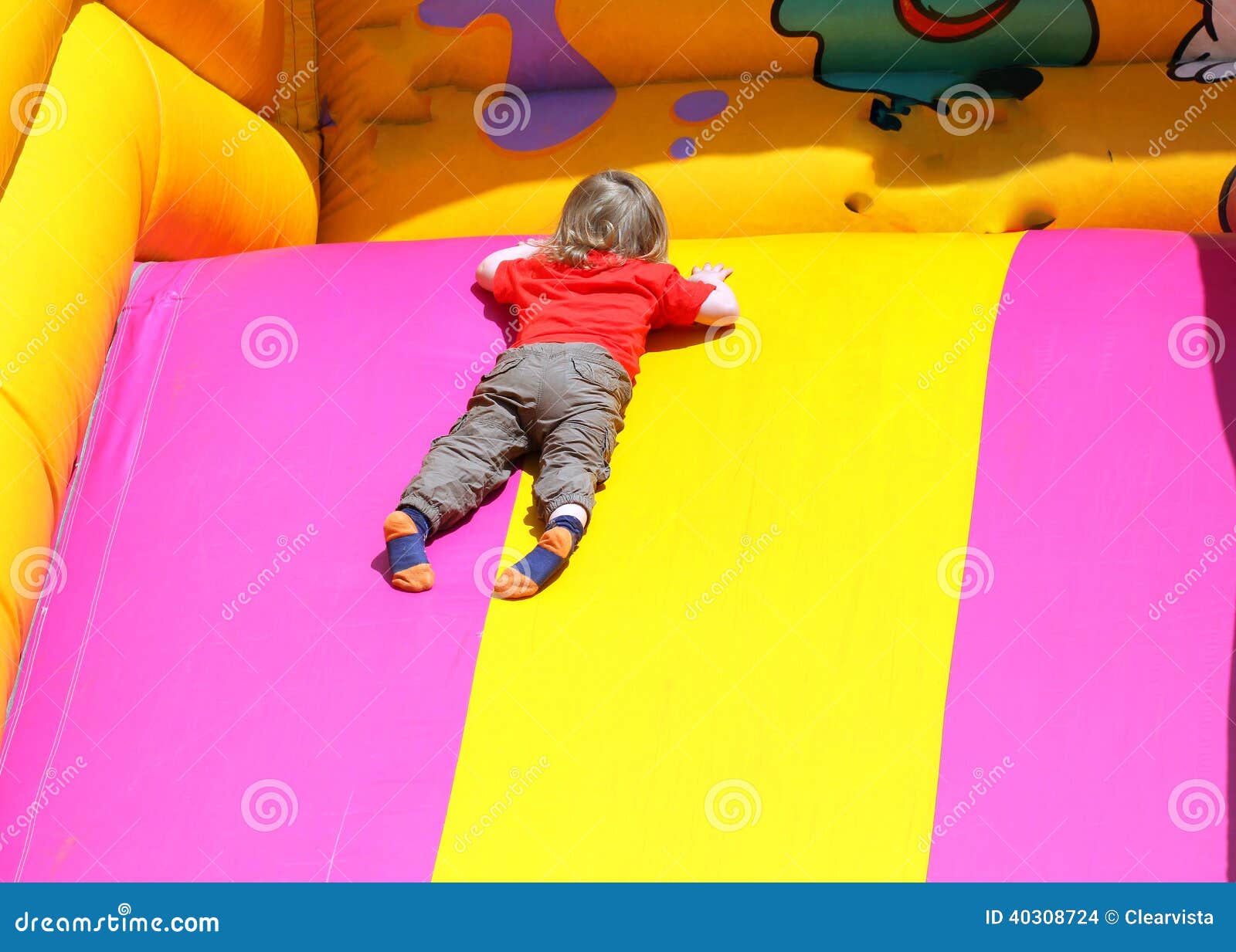 Child playing on a slide. stock photo. Image of playing - 40308724