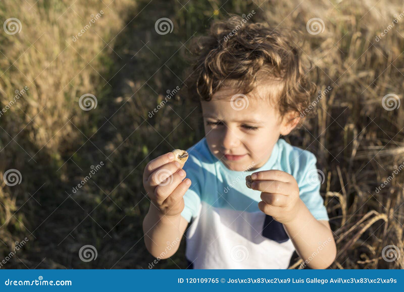 Child Playing with Some Snails. Stock Image - Image of sunset, values ...