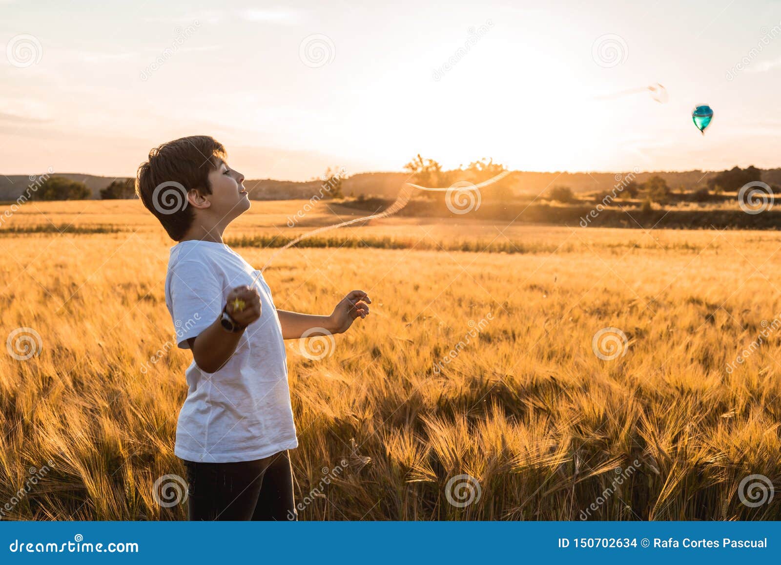 Child Playing with a Spinning Top on the Field Stock Photo - Image of ...