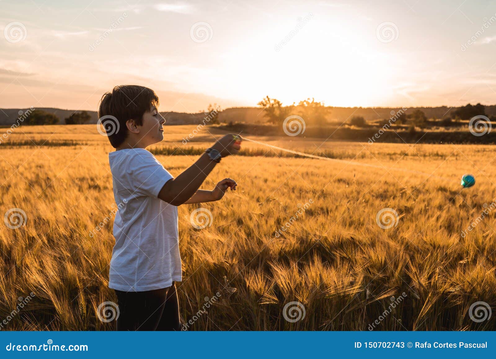 Child Playing with a Spinning Top on the Field Stock Image - Image of ...