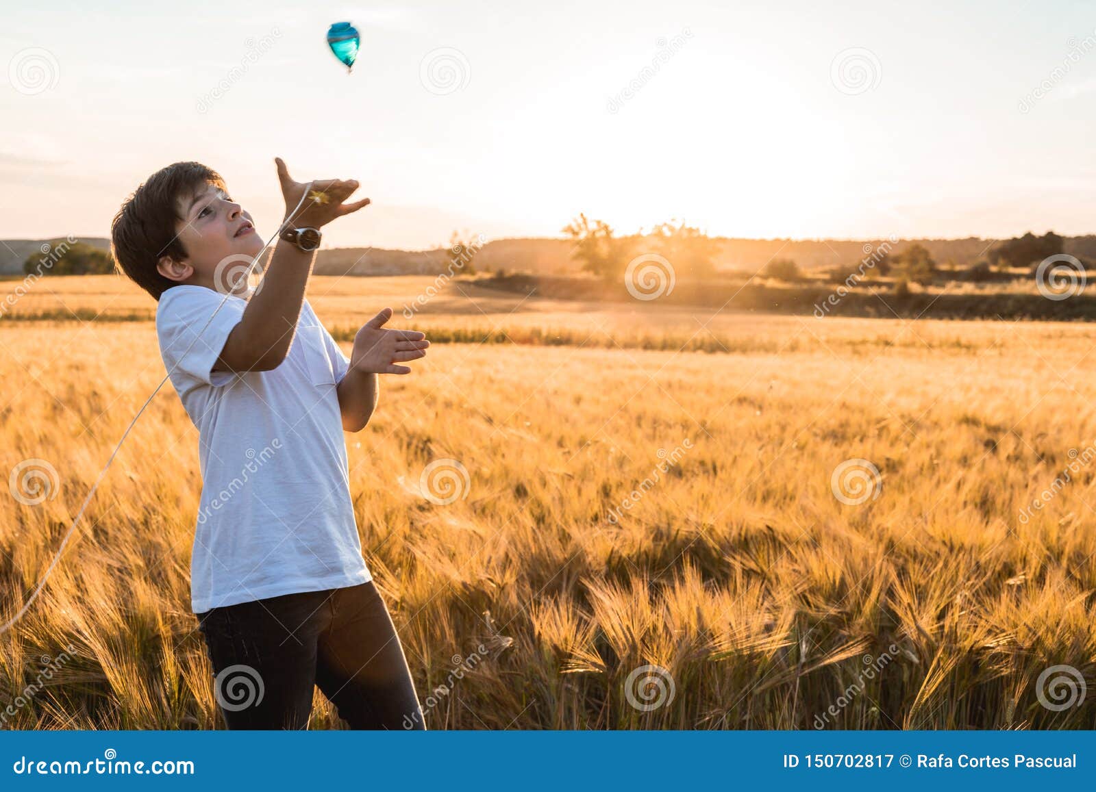 Child Playing with a Spinning Top on the Field Stock Image - Image of ...